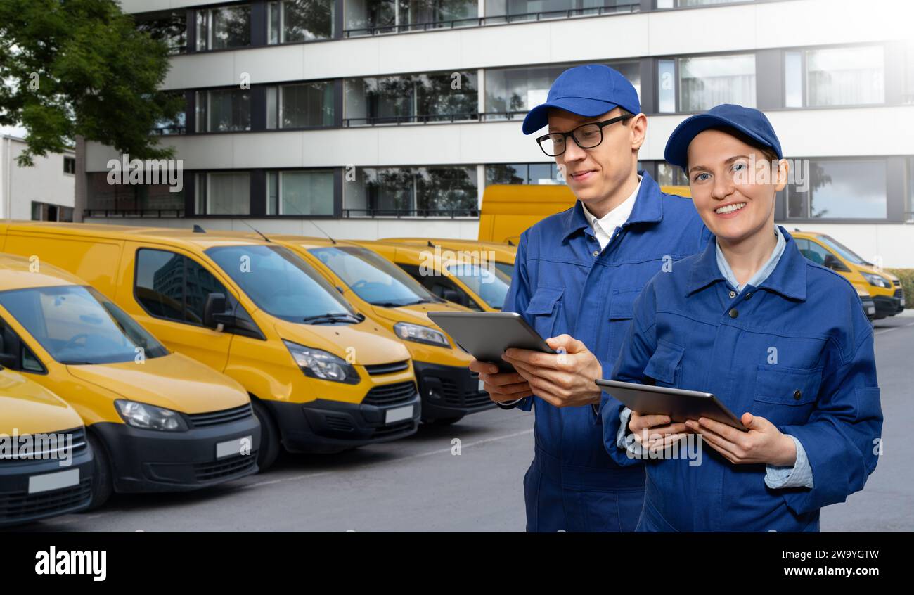 Team of managers with a digital tablets on the background of trucks ...