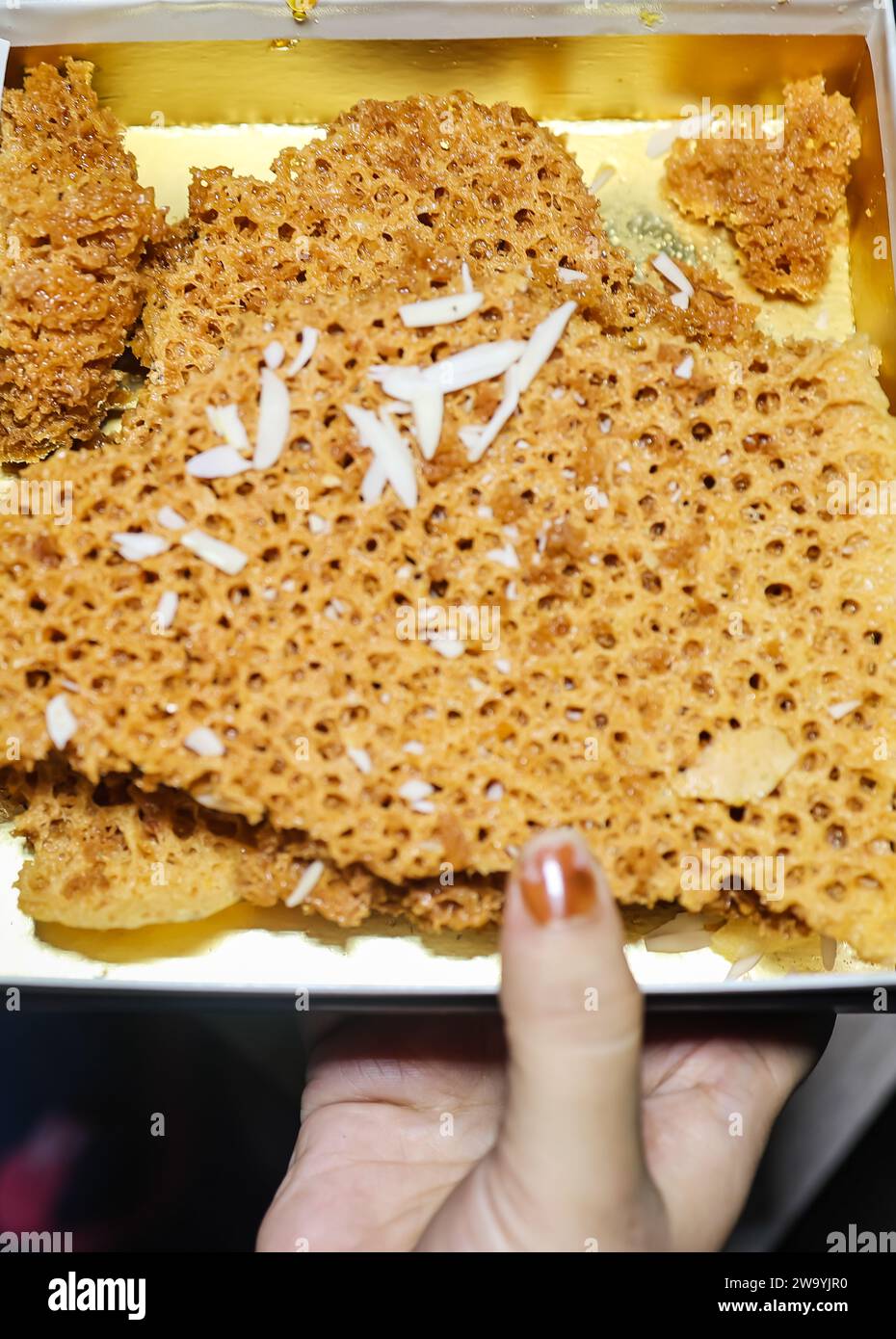 people sharing ghewar traditional indian delicious sweet close up shot ...