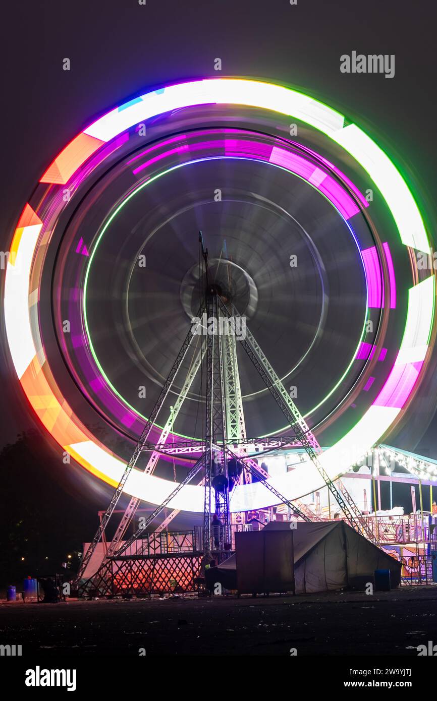 merry go round swing at night with colorful light at city fair ground ...
