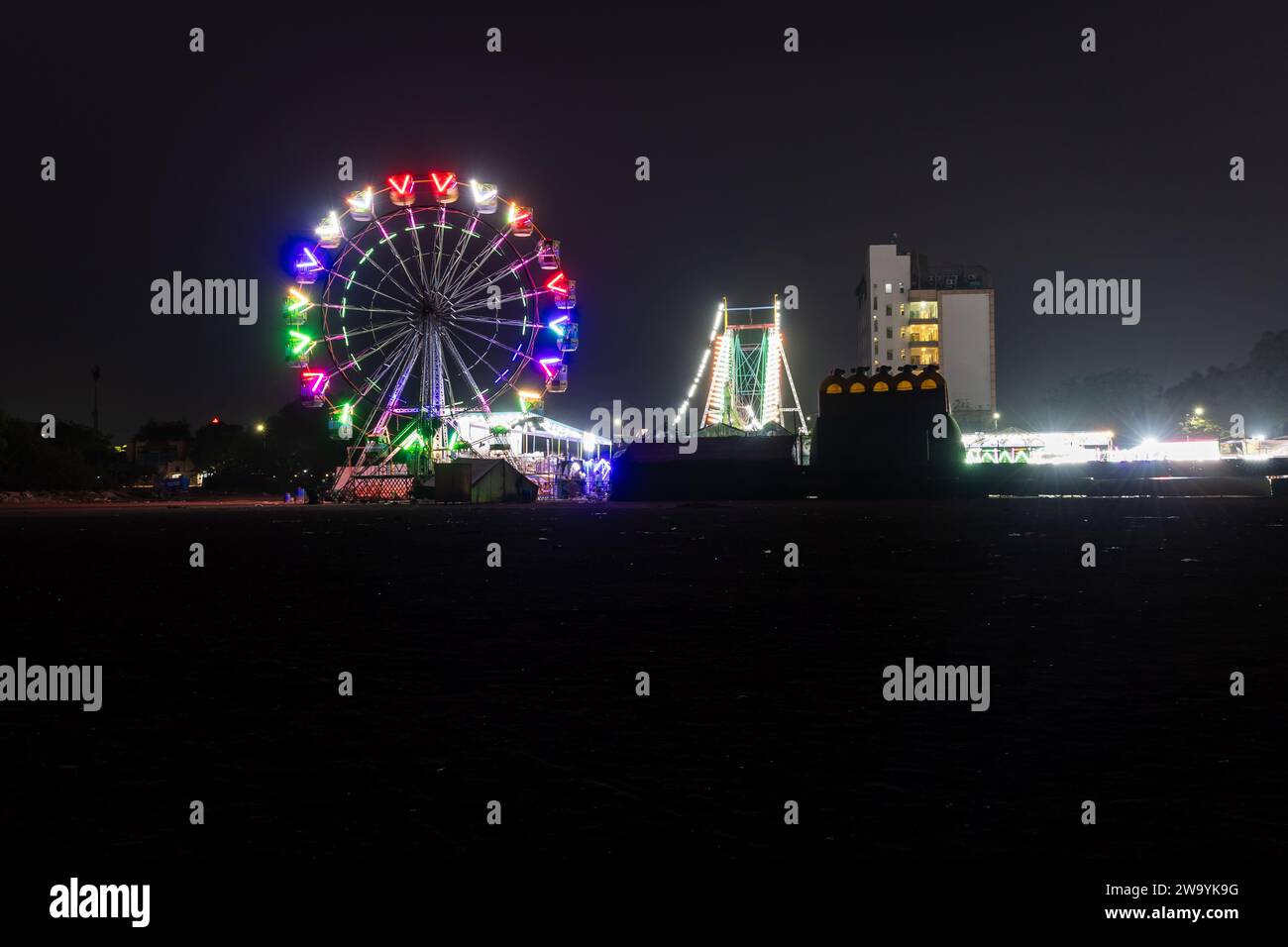 merry go round swing at night with colorful light at city fair ground ...
