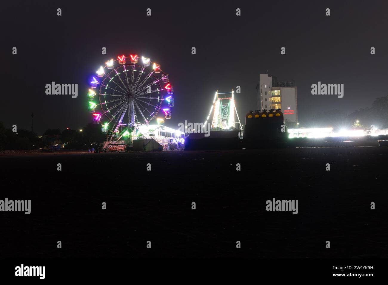 merry go round swing at night with colorful light at city fair ground ...