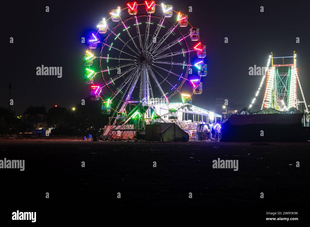 merry go round swing at night with colorful light at city fair ground ...