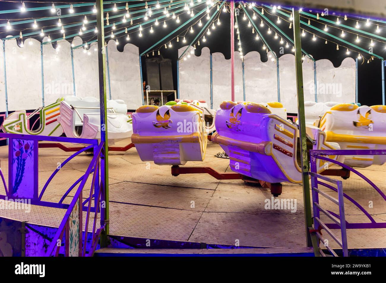 merry go round swing at night with colorful light at city fair ground ...