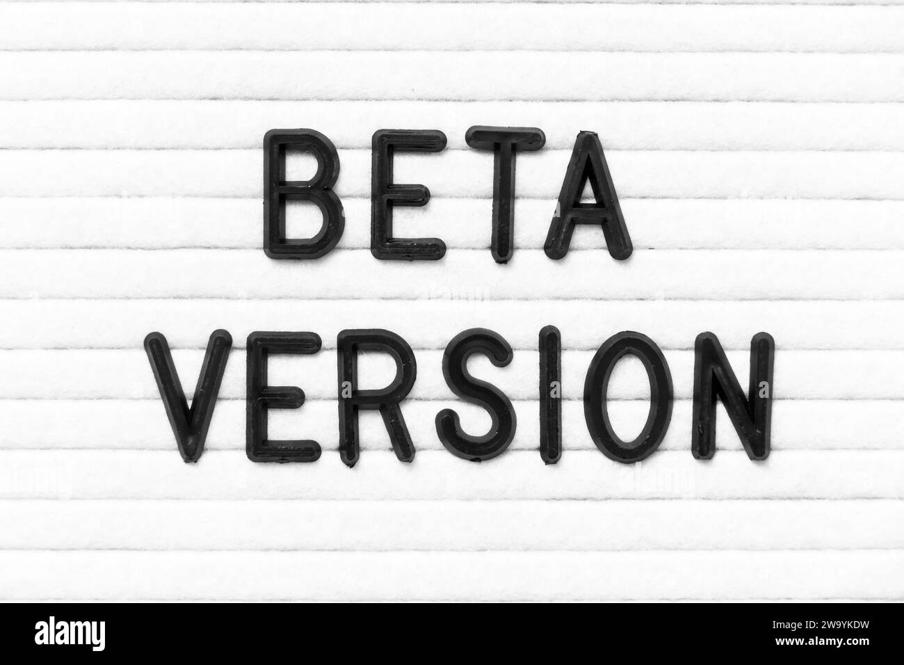 Black color letter in word beta version on white felt board background ...