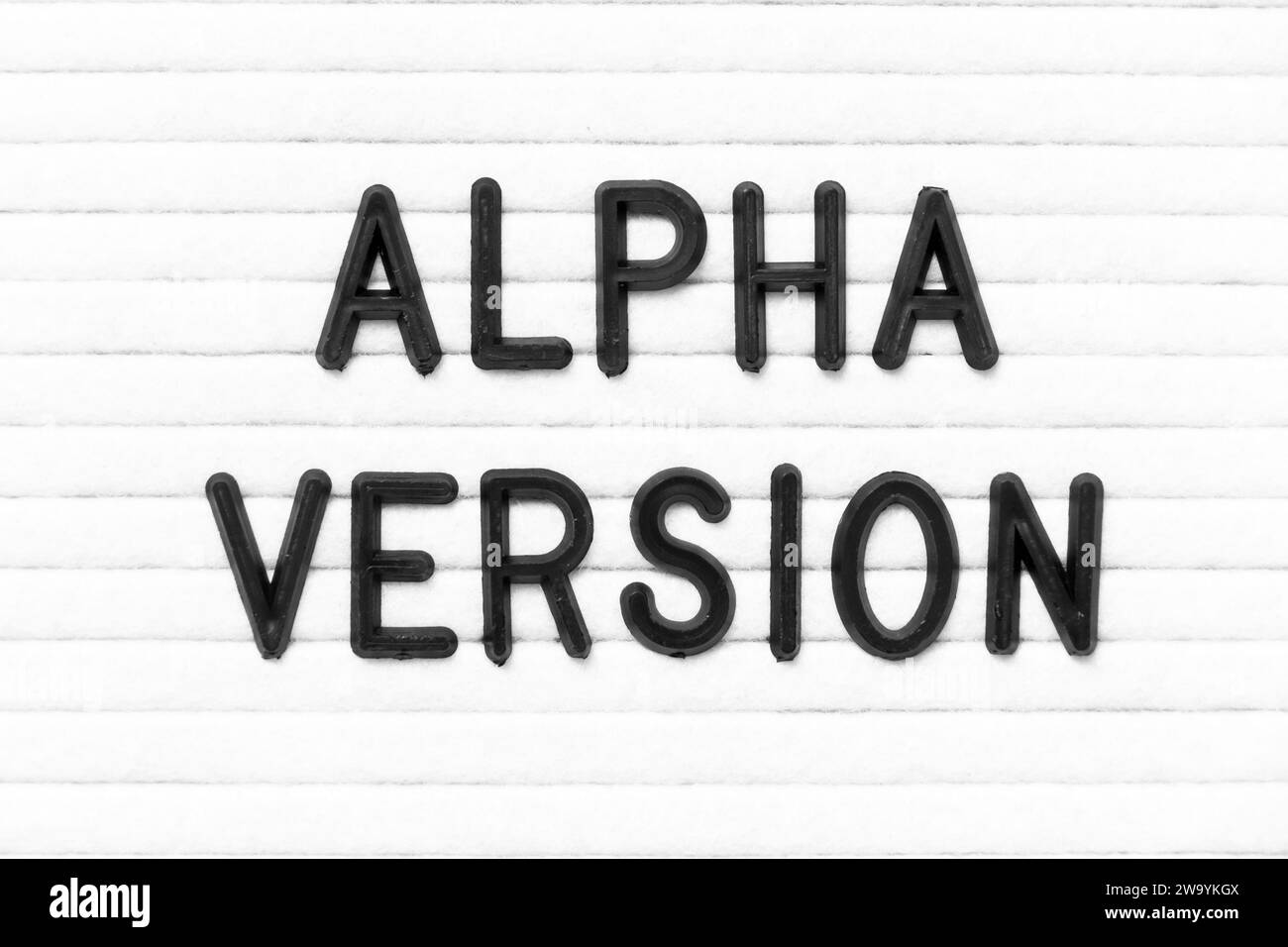 Black color letter in word alpha version on white felt board background ...