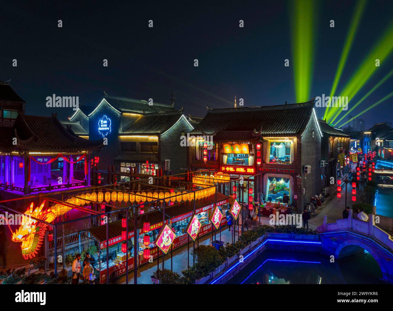 HUAI'AN, CHINA - DECEMBER 31, 2023 - Tourists enjoy the bright lights ...