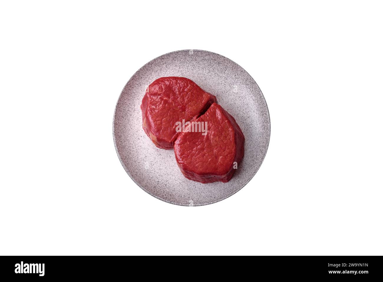 Fresh juicy raw filet mignon with salt, spices and herbs on a dark ...