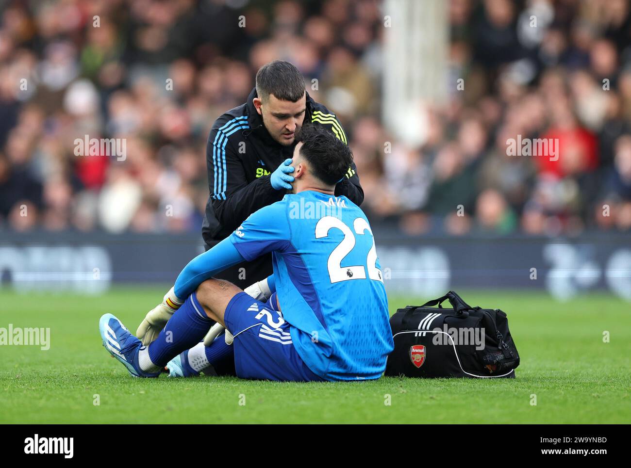 Arsenal goalkeeper David Raya receives treatment for an injury during ...