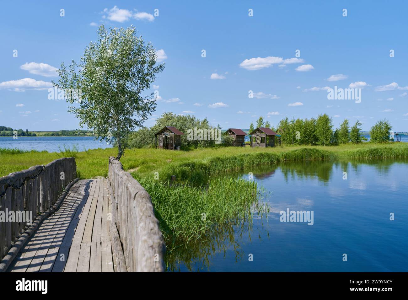 Small camping cabins on the shore by the lake Stock Photo - Alamy