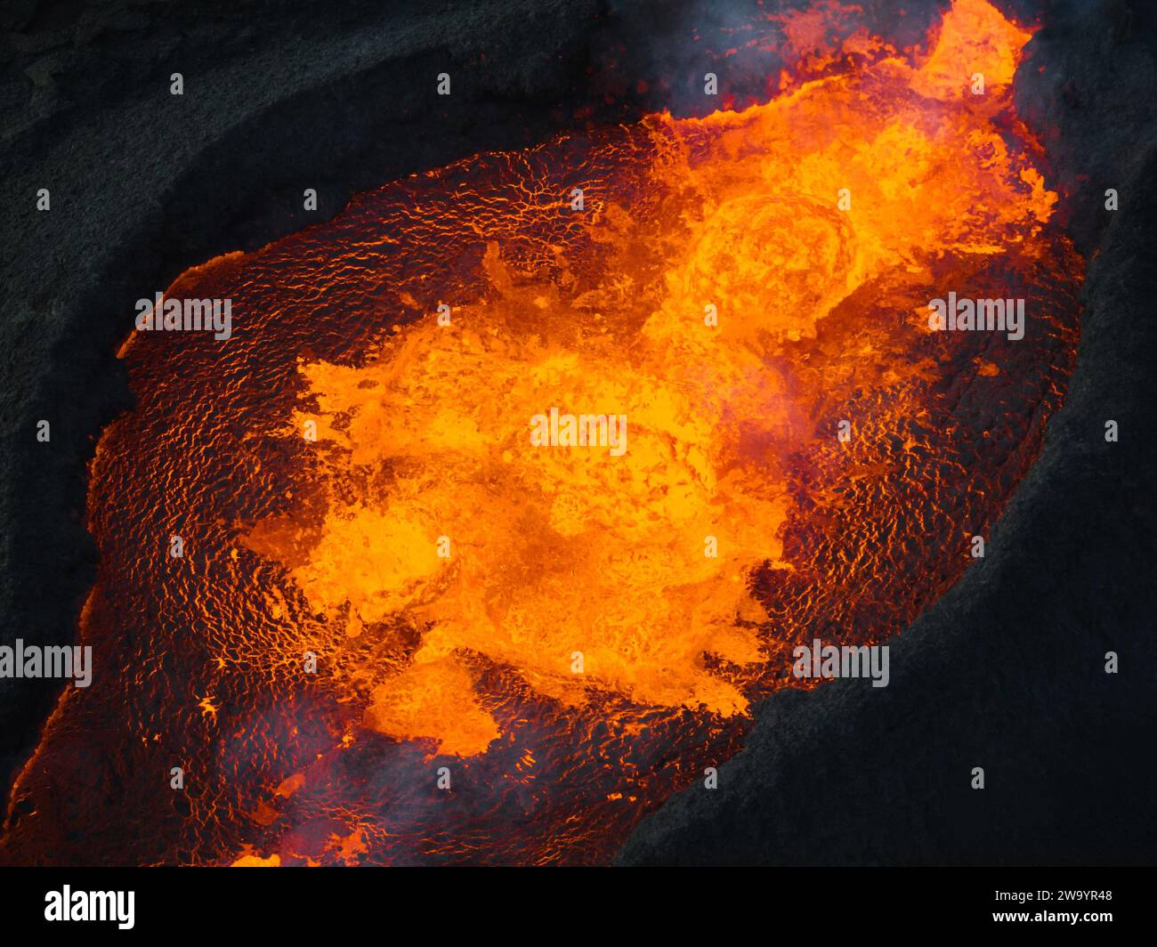 Fantastic directly above close-up shot of boiling glowing lava inside a ...