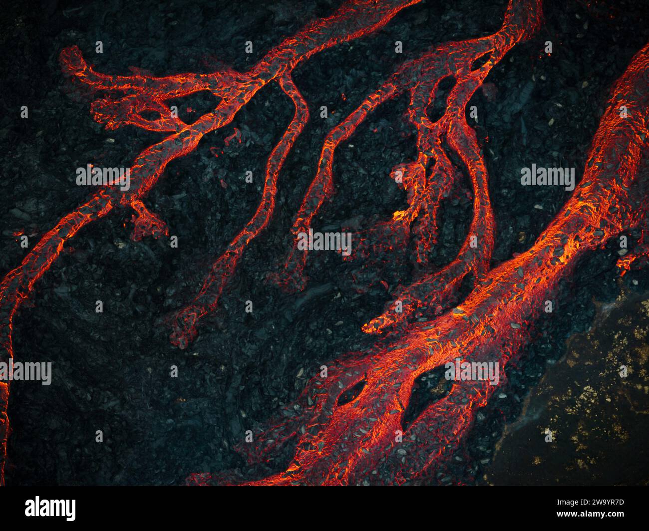 Streams of red hot lava flowing during a volcano eruption, toxic smoke ...