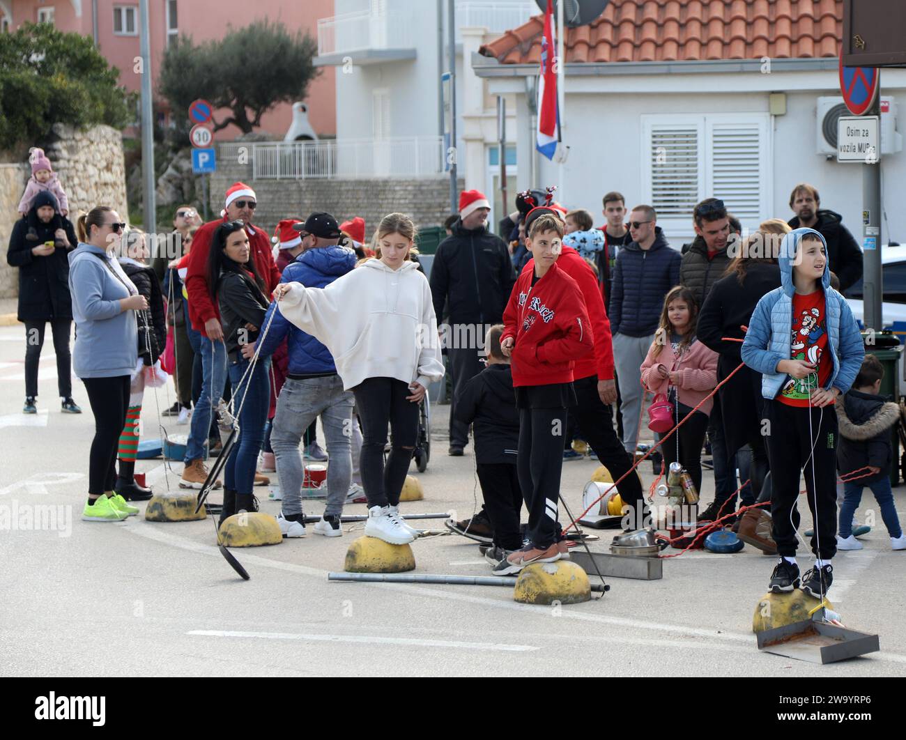 Primosten, Croatia. 31st Dec, 2023. People walk and drag their pots ...
