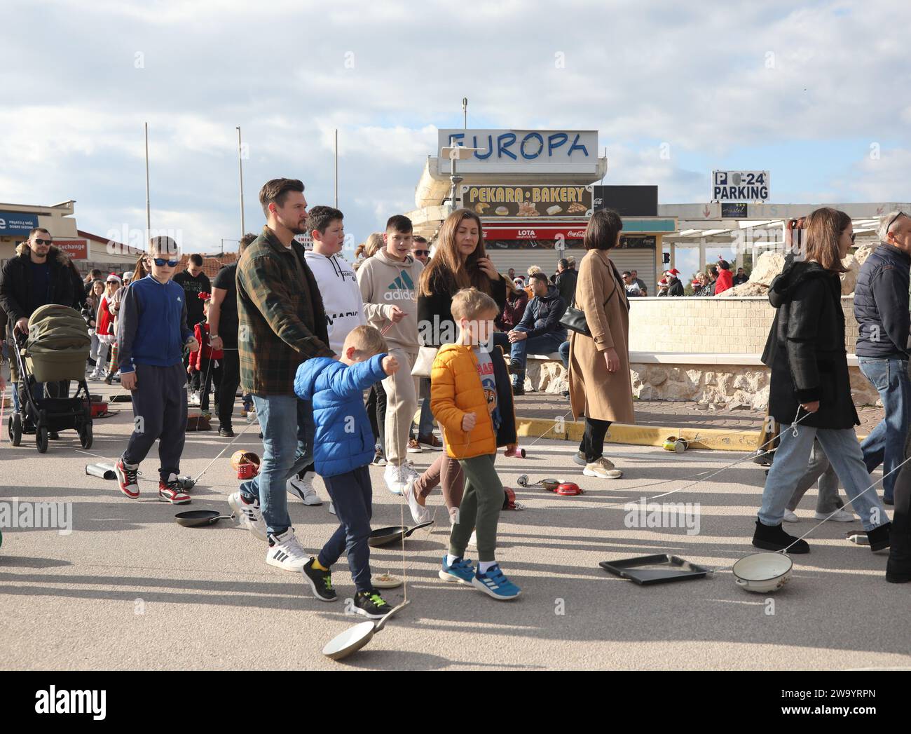Primosten, Croatia. 31st Dec, 2023. People walk and drag their pots ...