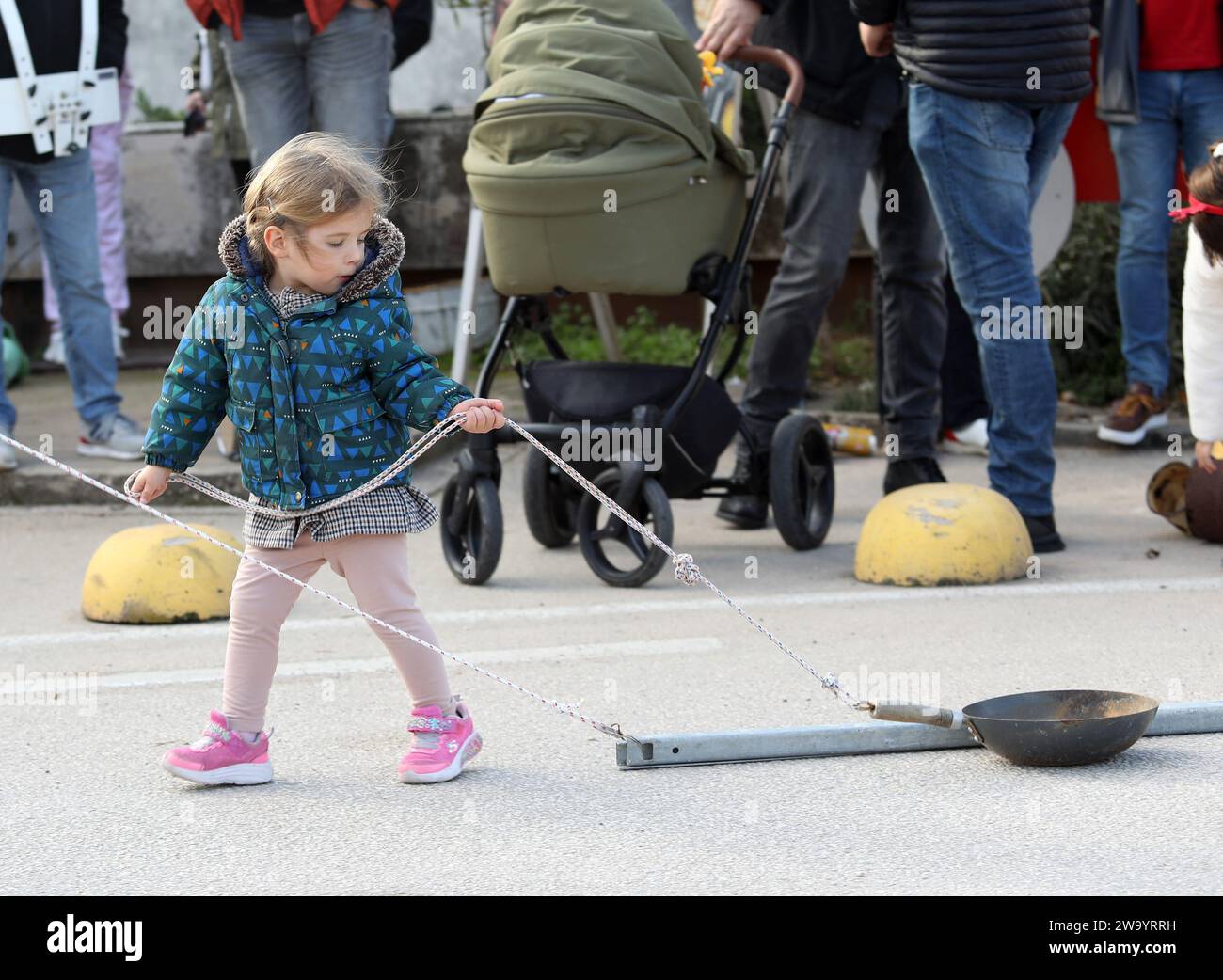 Primosten, Croatia. 31st Dec, 2023. People walk and drag their pots ...