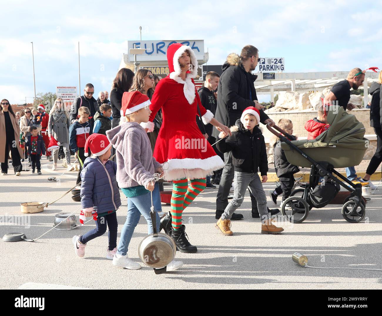 Primosten, Croatia. 31st Dec, 2023. People walk and drag their pots ...