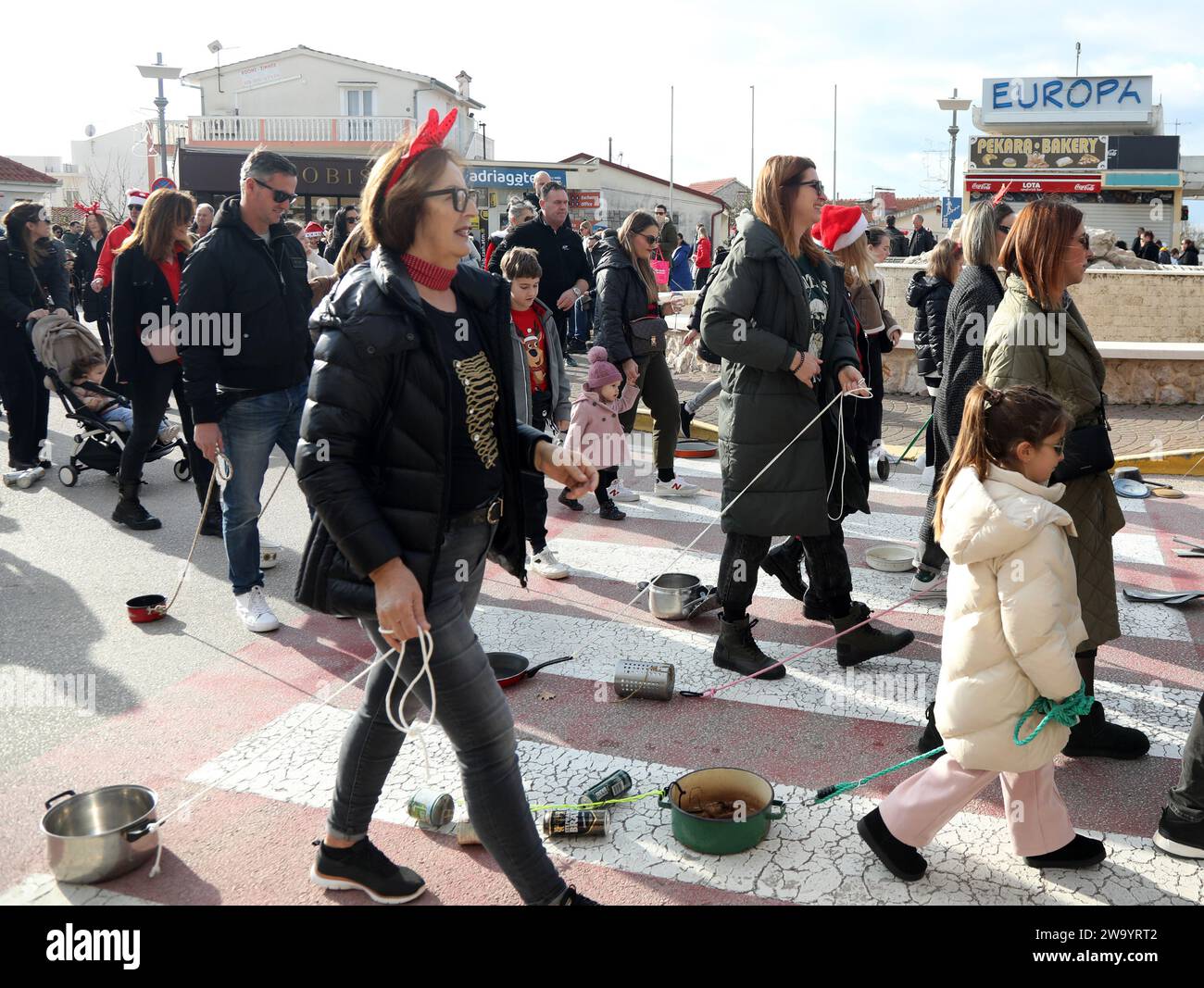 Primosten, Croatia. 31st Dec, 2023. People walk and drag their pots ...