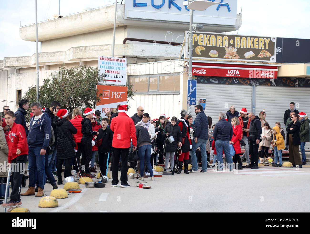 Primosten, Croatia. 31st Dec, 2023. People walk and drag their pots ...