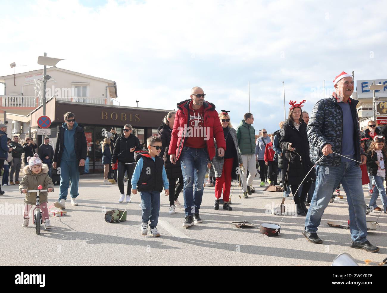 Primosten, Croatia. 31st Dec, 2023. People walk and drag their pots ...