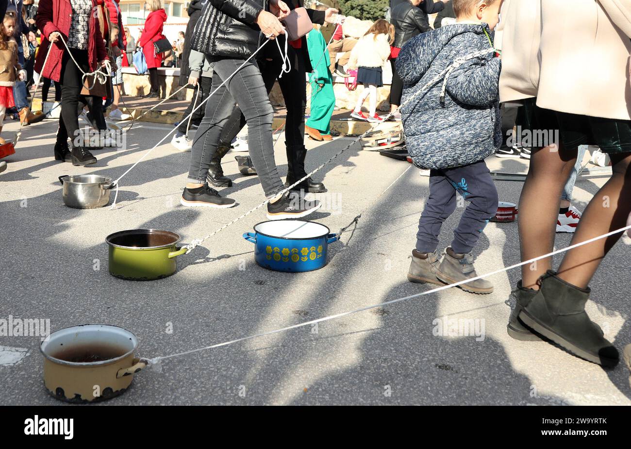 Primosten, Croatia. 31st Dec, 2023. People walk and drag their pots ...