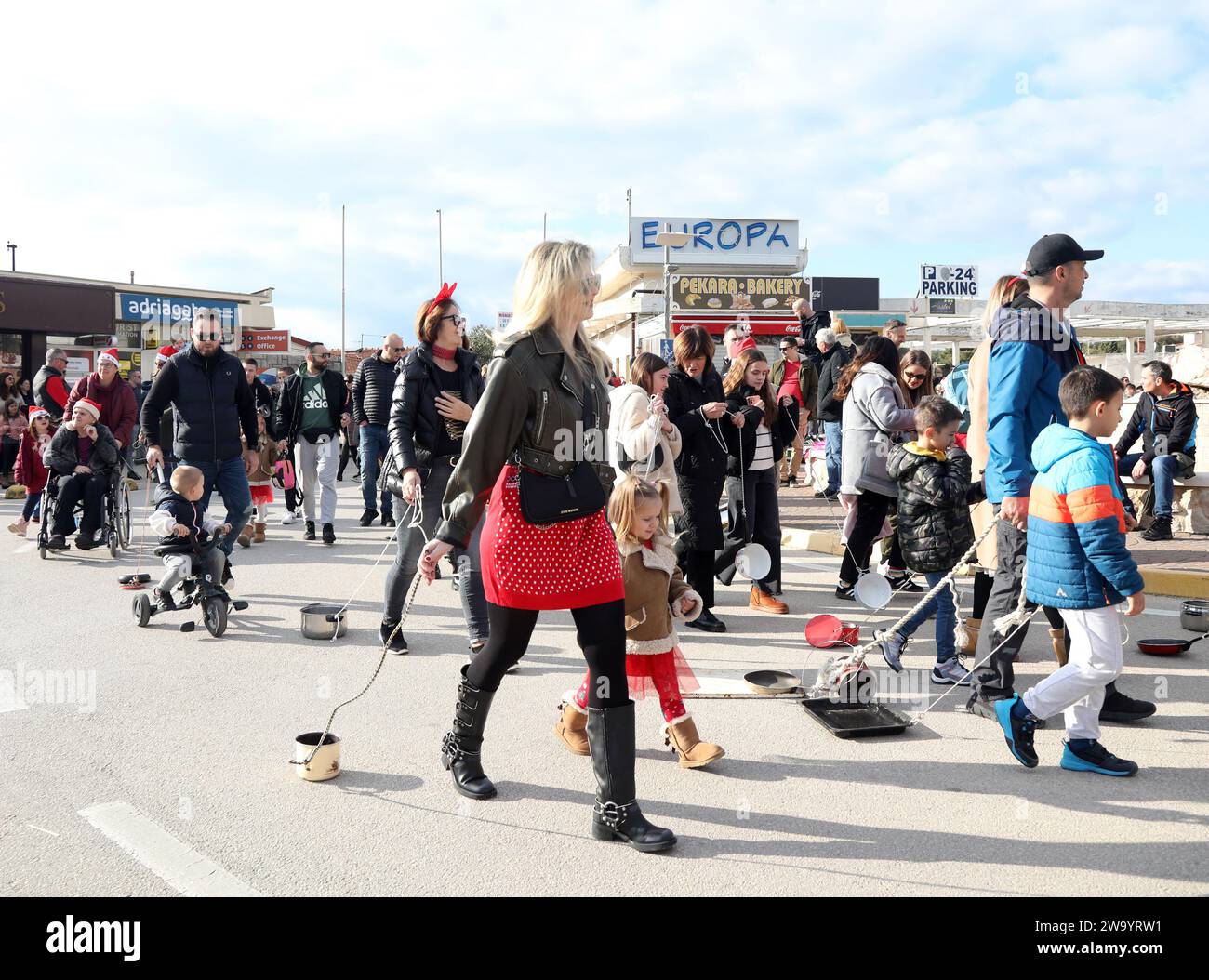 Primosten, Croatia. 31st Dec, 2023. People walk and drag their pots ...