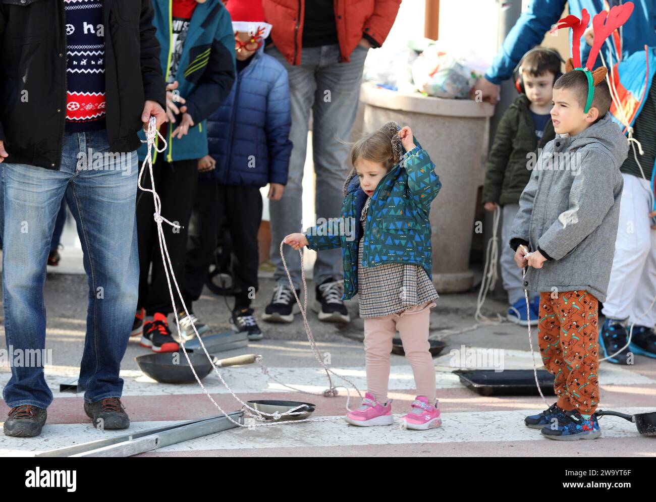 Primosten, Croatia. 31st Dec, 2023. People walk and drag their pots ...