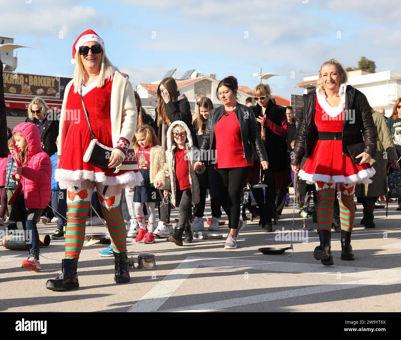 Primosten, Croatia. 31st Dec, 2023. People walk and drag their pots ...