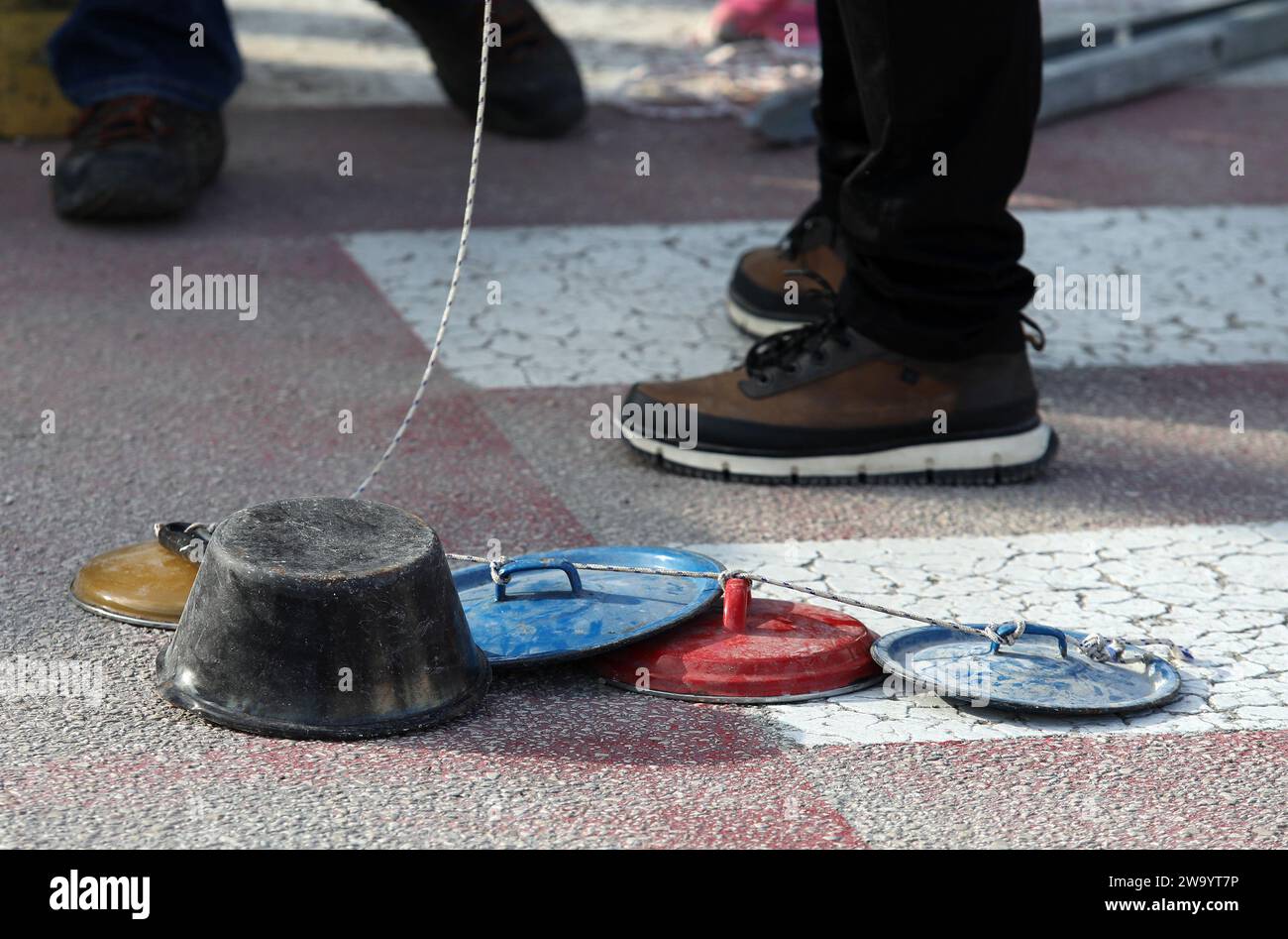 Primosten, Croatia. 31st Dec, 2023. People walk and drag their pots ...