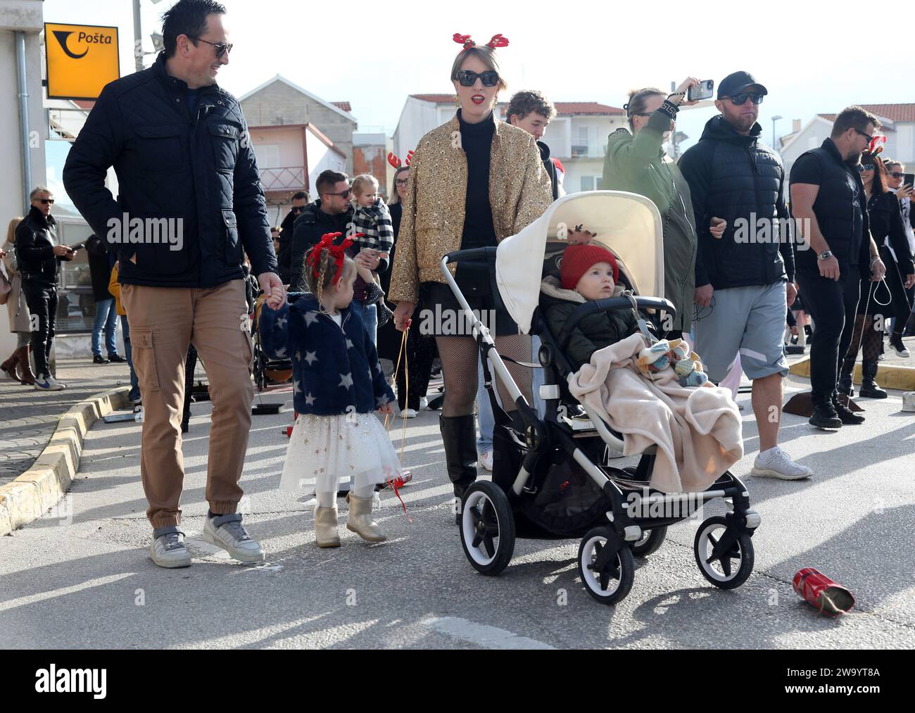 Primosten, Croatia. 31st Dec, 2023. People walk and drag their pots ...
