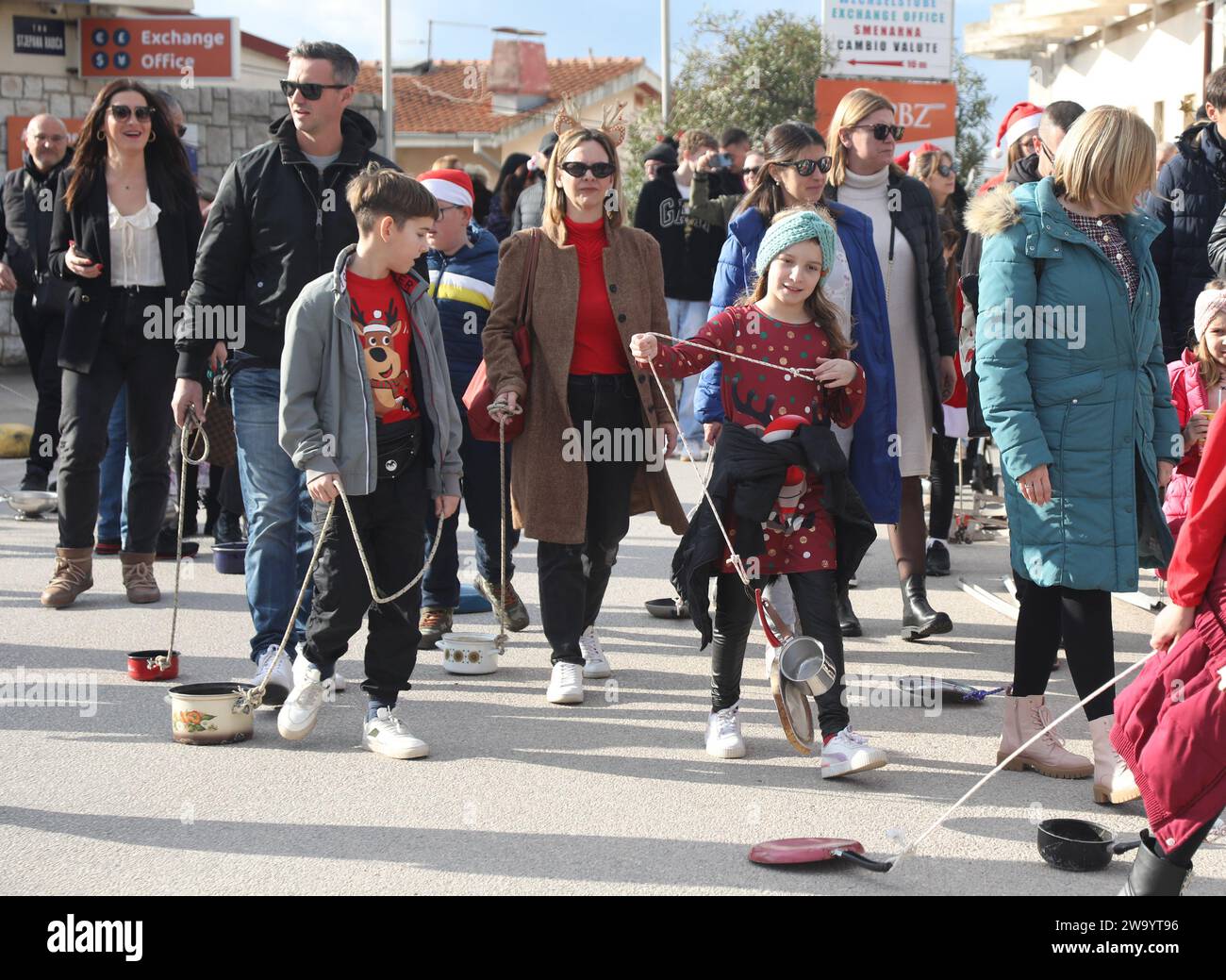 Primosten, Croatia. 31st Dec, 2023. People walk and drag their pots ...
