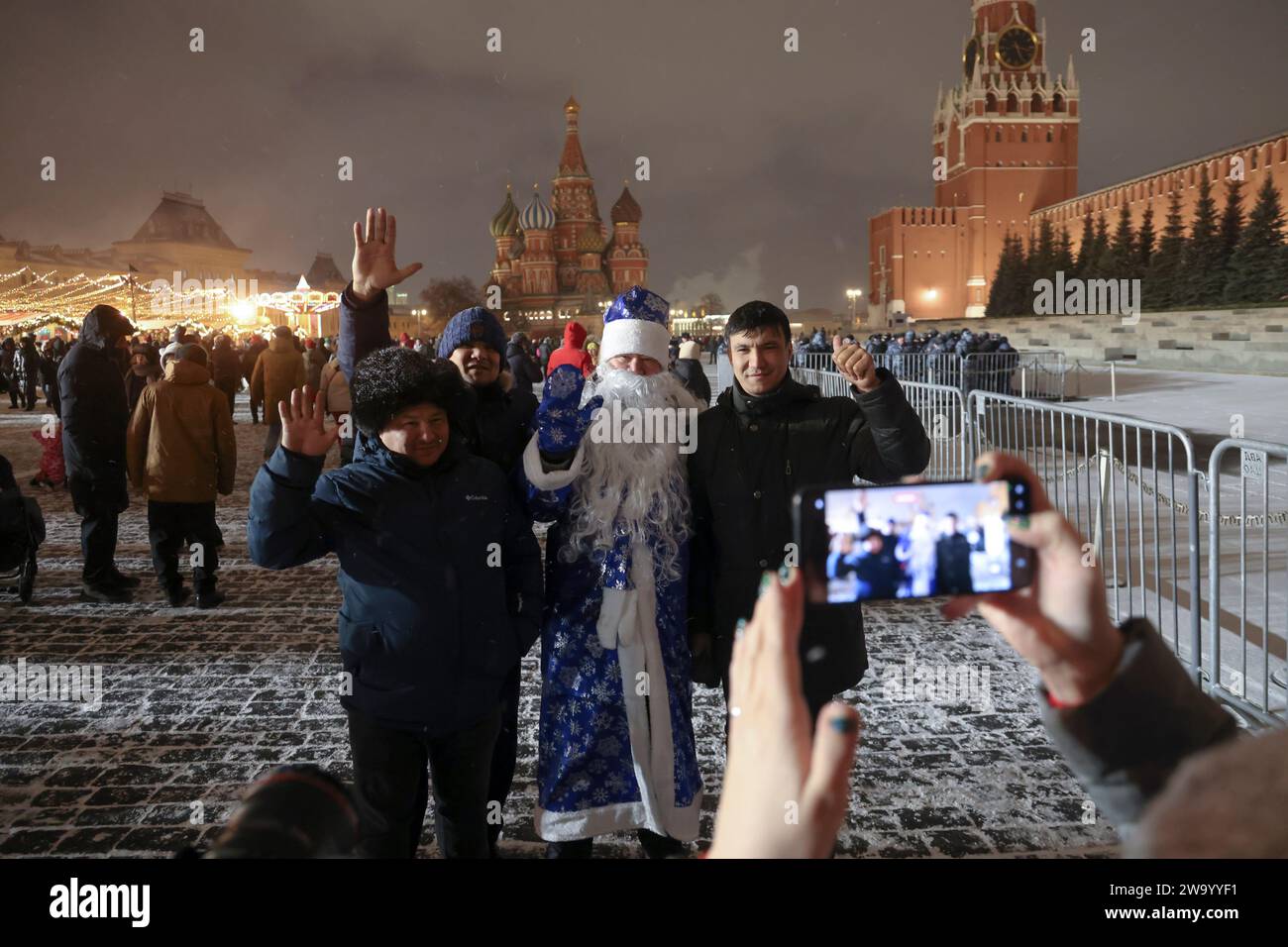 People pose for a photo with an actor dressed as Ded Moroz, Grandfather ...