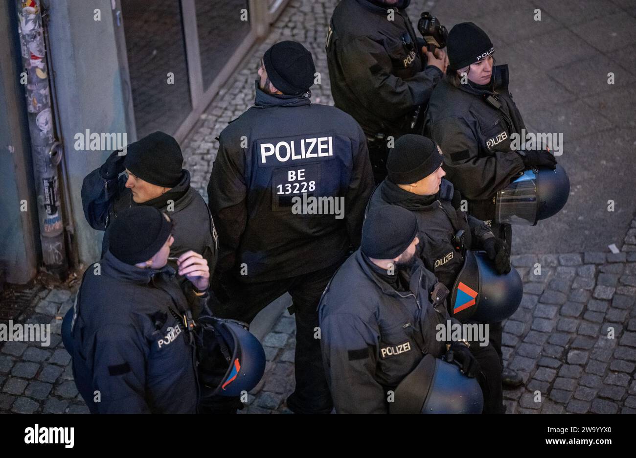 Berlin, Germany. 31st Dec, 2023. Police officers stand at a pro ...