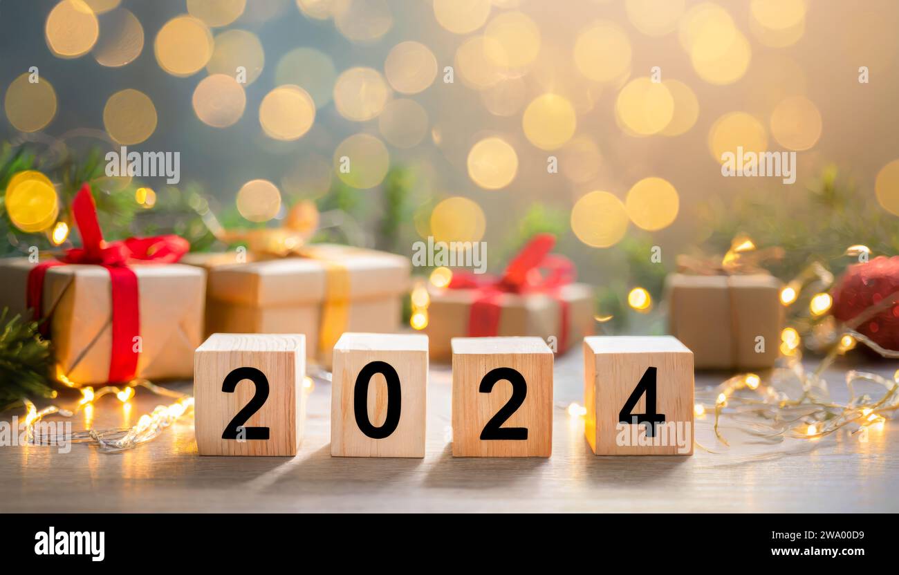 A stack of wooden cube with defocused lights. 2024 new year concept ...