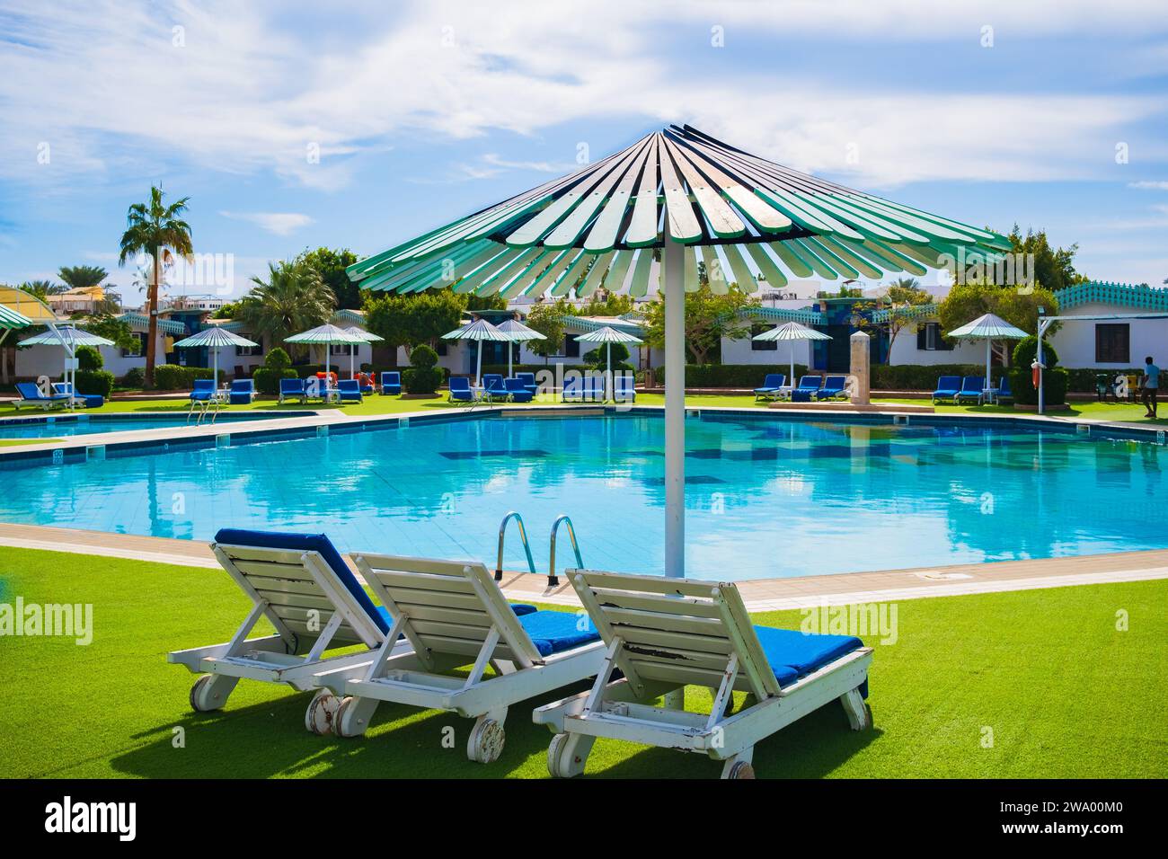 Beautiful swimming pool in tropical resort with palms. Swimming pool ...