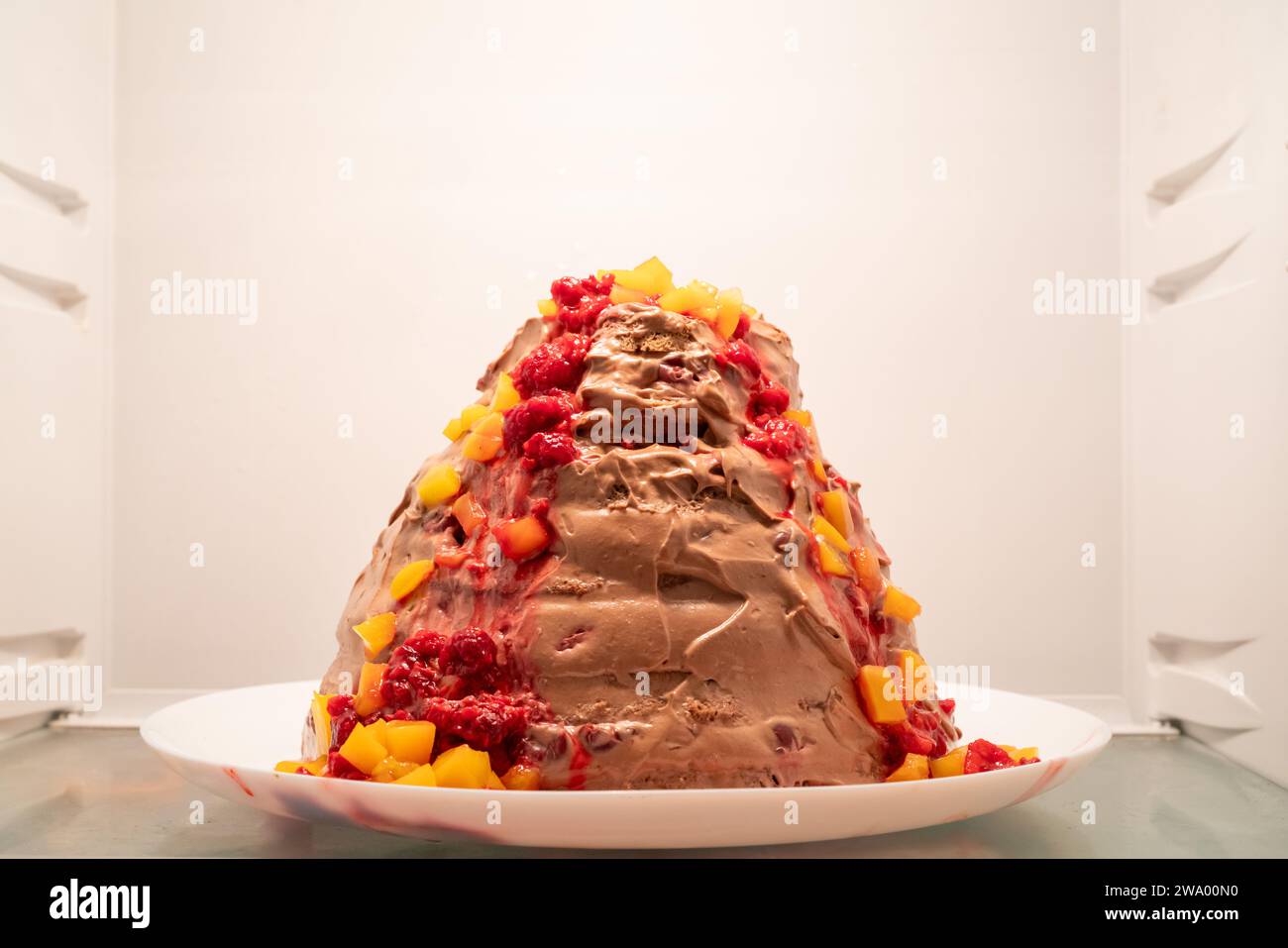 Homemade tall chocolate cake decorated with raspberries and peaches in ...