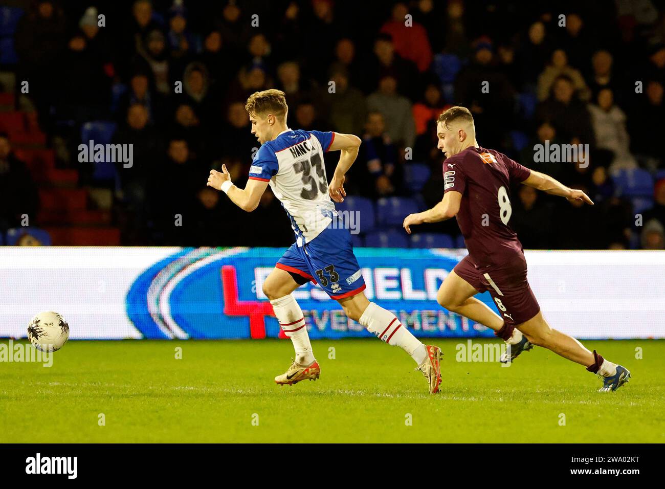 Mitch Hancox of Hartlepool United Football Club is tussling with Josh ...