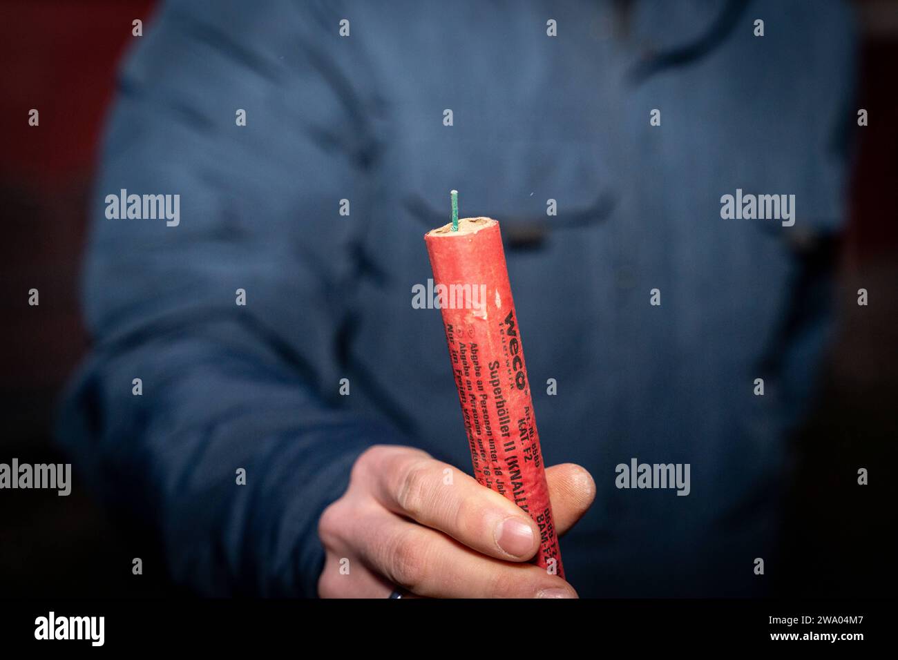 Kammlach, Bavaria, Germany - December 31, 2023: Man holding a large ...