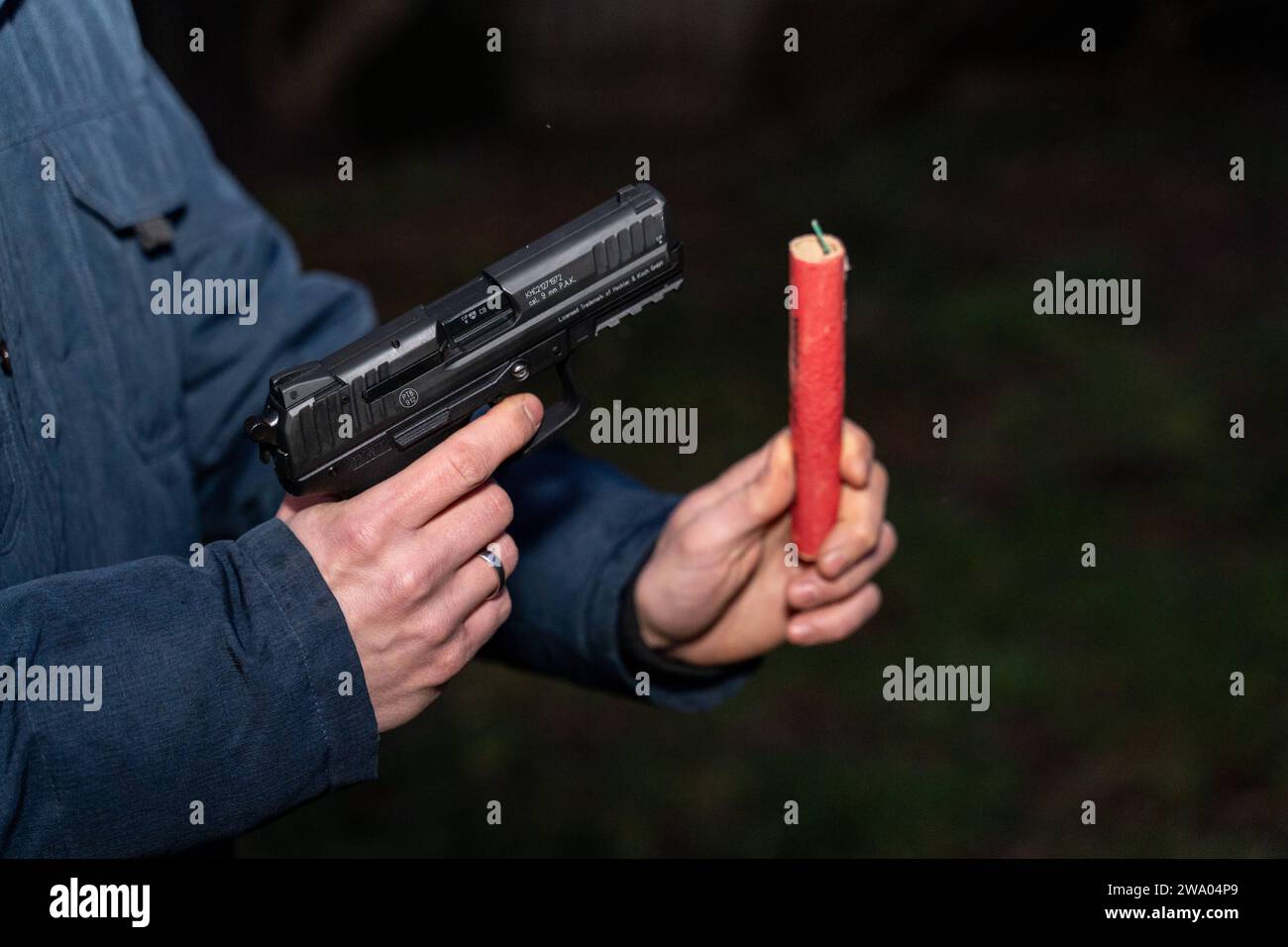 Kammlach, Bavaria, Germany - December 31, 2023: Man holding a New Year ...
