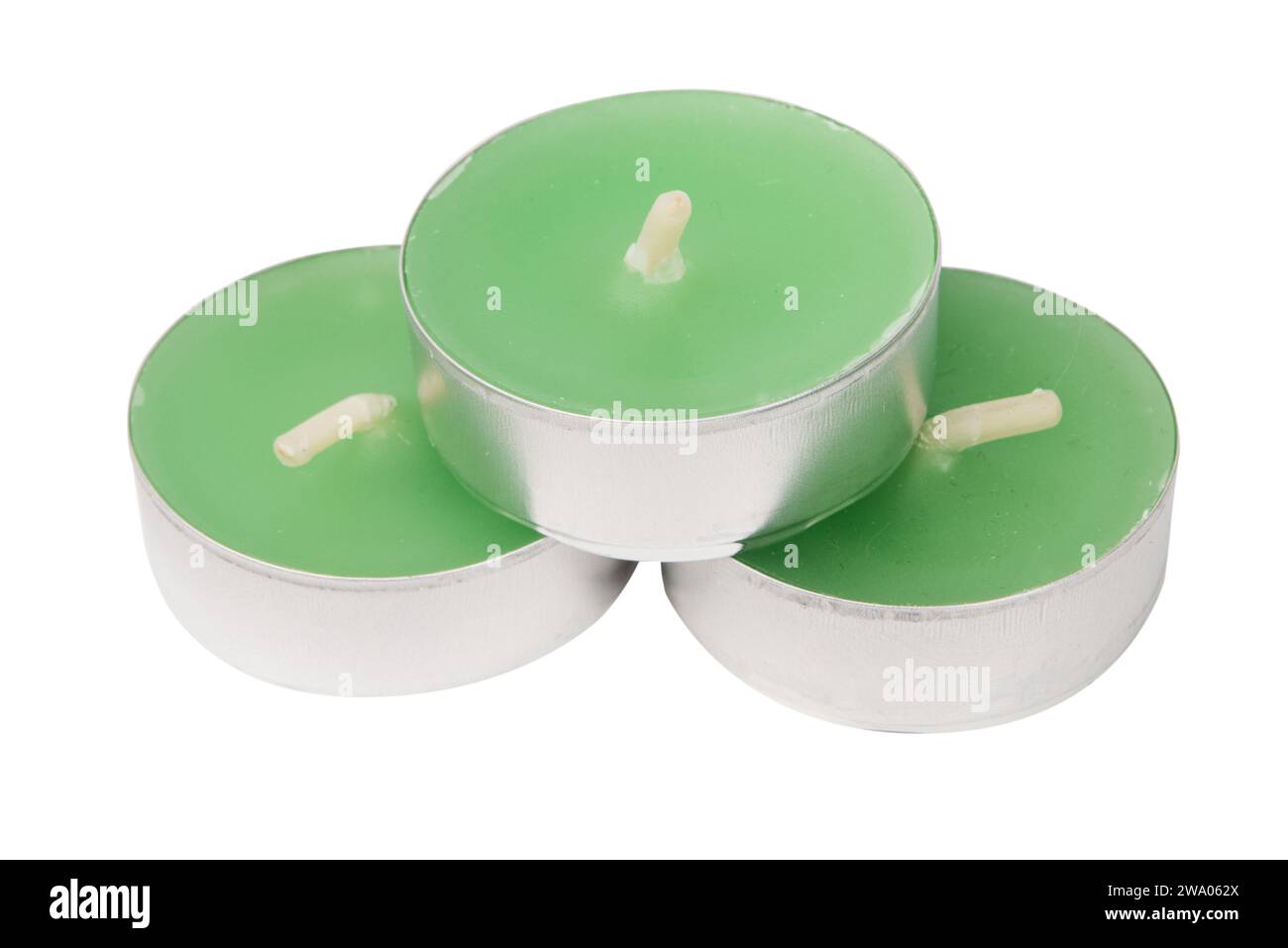 Green decorative tea light candles in aluminum holders stack isolated ...