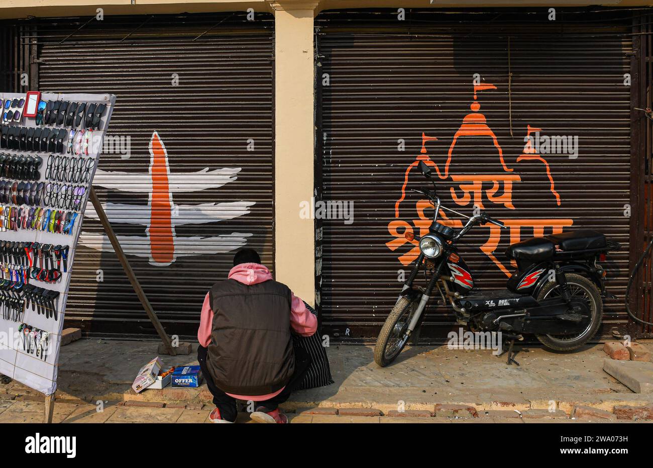 A vendor sits next to a work of art depicting Ram, one of the most ...