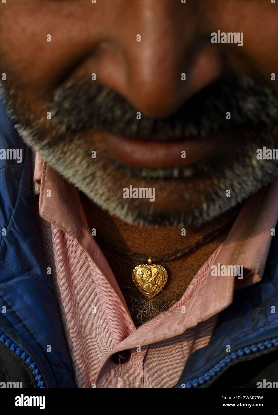 Ayodhya, India. 27th Dec, 2023. A devotee poses for a photo with the ...