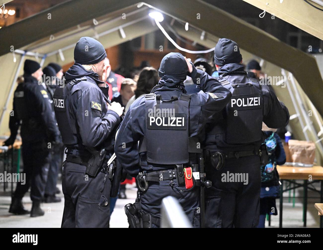 Cologne, Germany. 31st Dec, 2023. Police officers on duty in front of ...