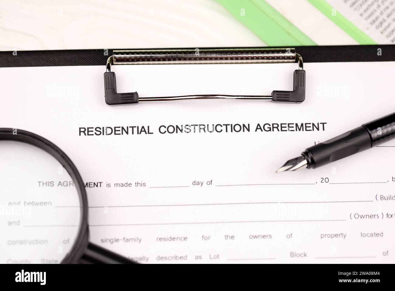 Construction contract form on A4 tablet lies on office table with pen ...