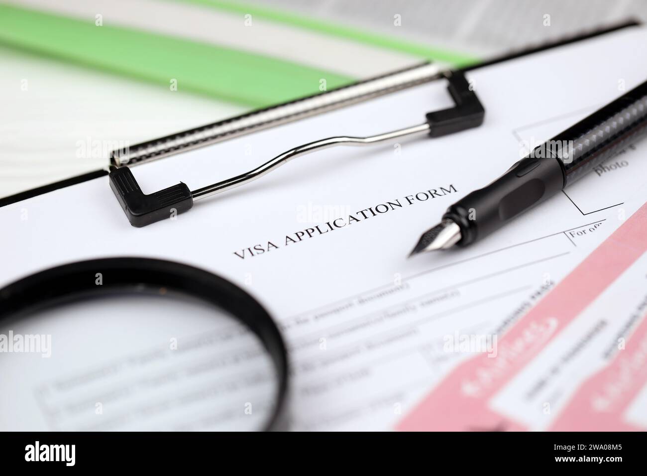 Typical Visa application form on A4 tablet lies on office table with ...