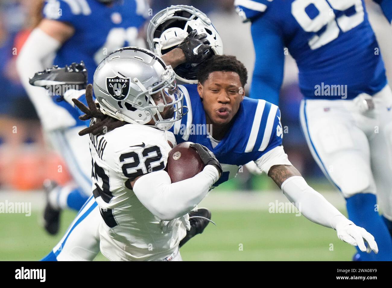 Indianapolis Colts cornerback Jaylon Jones, right, loses his helmet as ...