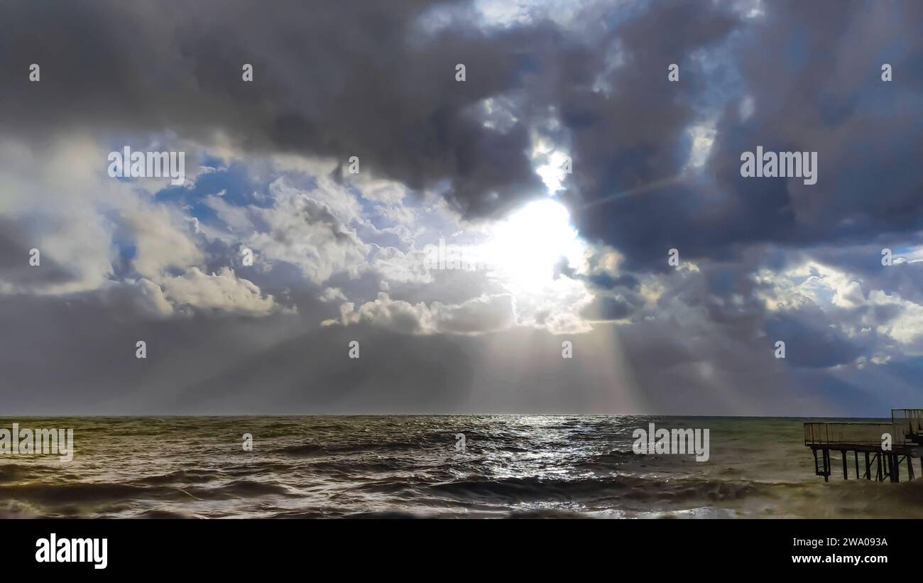 Landscape of stormy sea and clouds with gaps sun's rays, view from ...