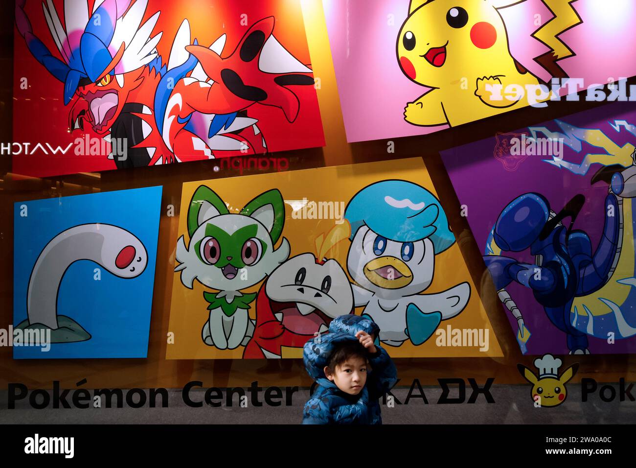 A boy stands in front of the Pokemon Store graffiti at Tokyo Station in ...
