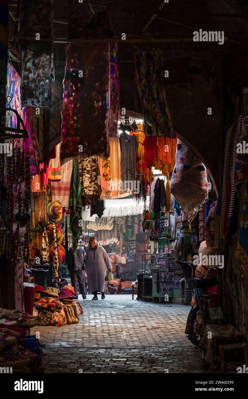 Local man dressed in traditional clothing strolls through the Marrakech ...
