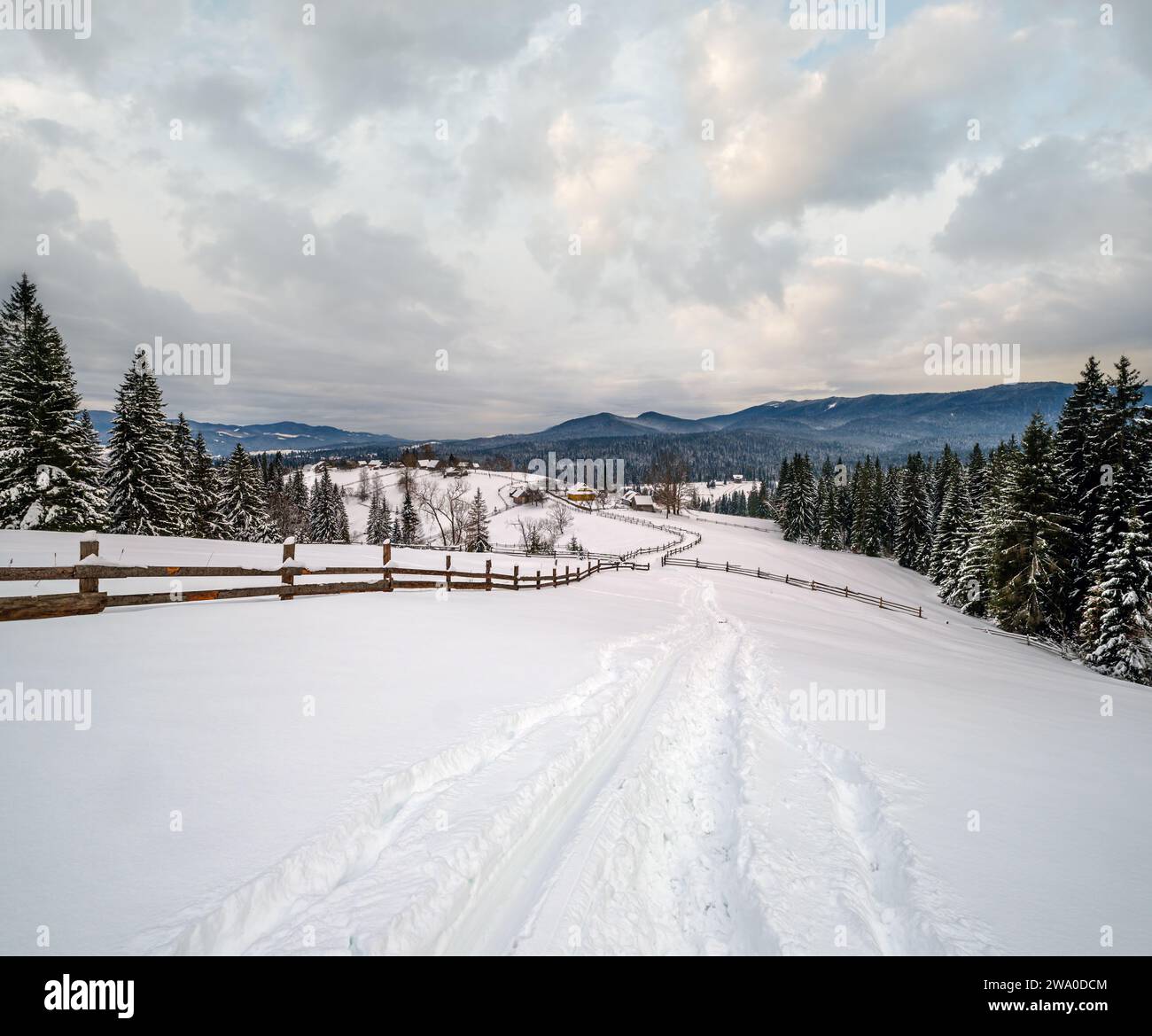 Secondary countryside alpine road in remote mountain village, snow ...