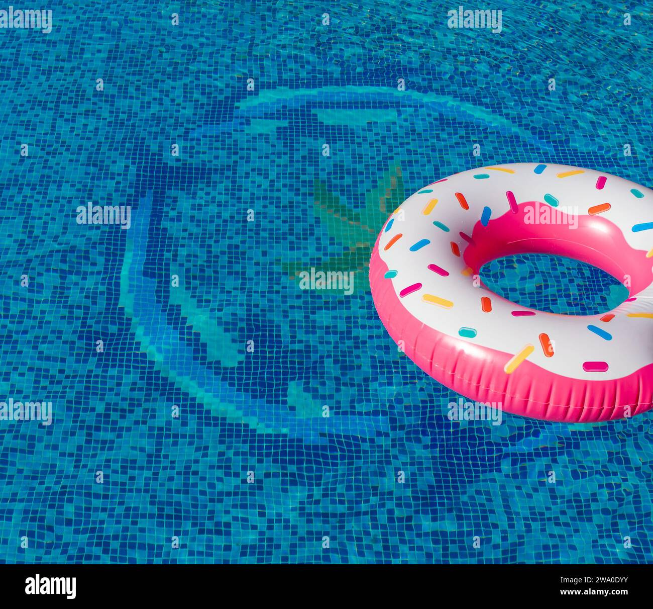 Pink inflatable donut swimming ring in a swimming pool Stock Photo - Alamy