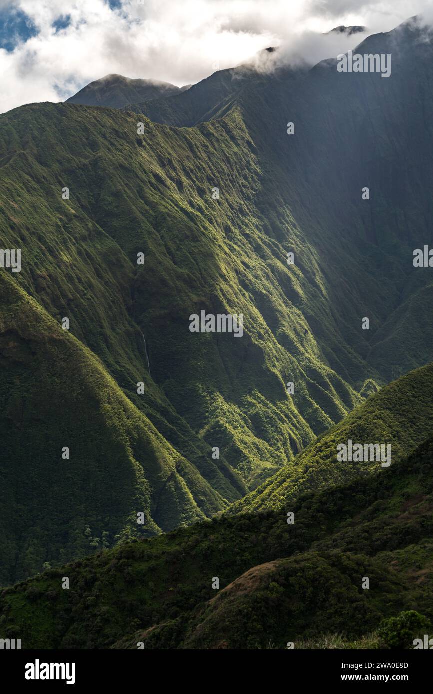 Light cascades down the lush mountain valley of Waihe'e Ridge in Maui ...